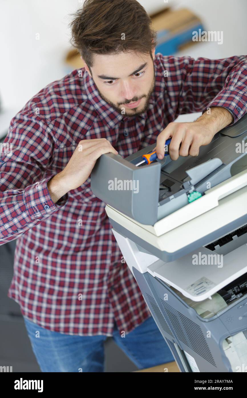 man mending the photocopier Stock Photo - Alamy