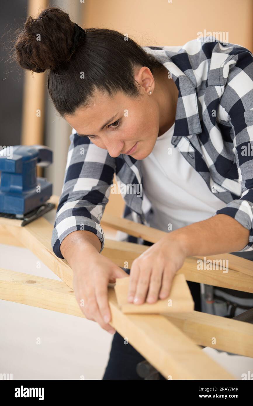 woman sanding wood with a sanding machine Stock Photo - Alamy