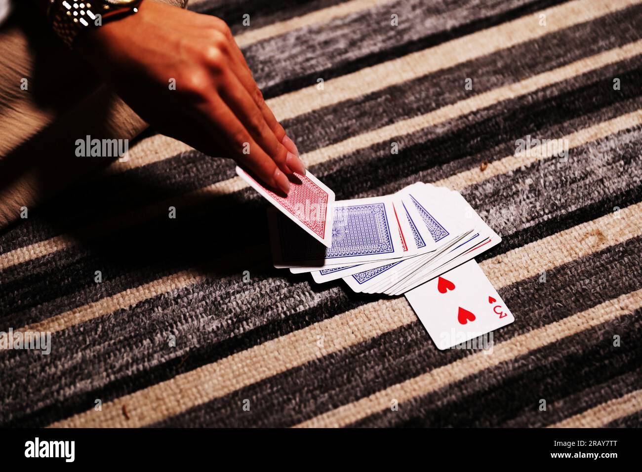 playing cards in a woman hand. Close-up of a player holding card in ...