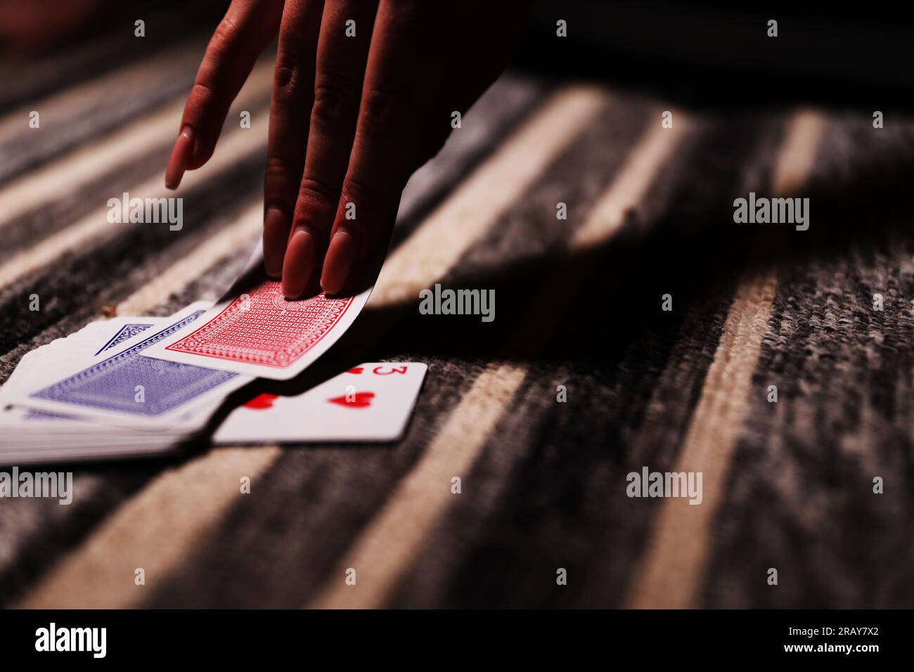 playing cards in a woman hand. Close-up of a player holding card in ...