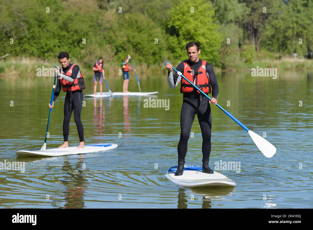 group of people on paddle boards on a lake Stock Photo - Alamy