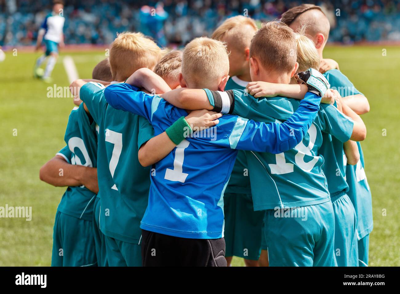 Powerful Team Unity: Children Huddling in Sports Team, Embracing ...