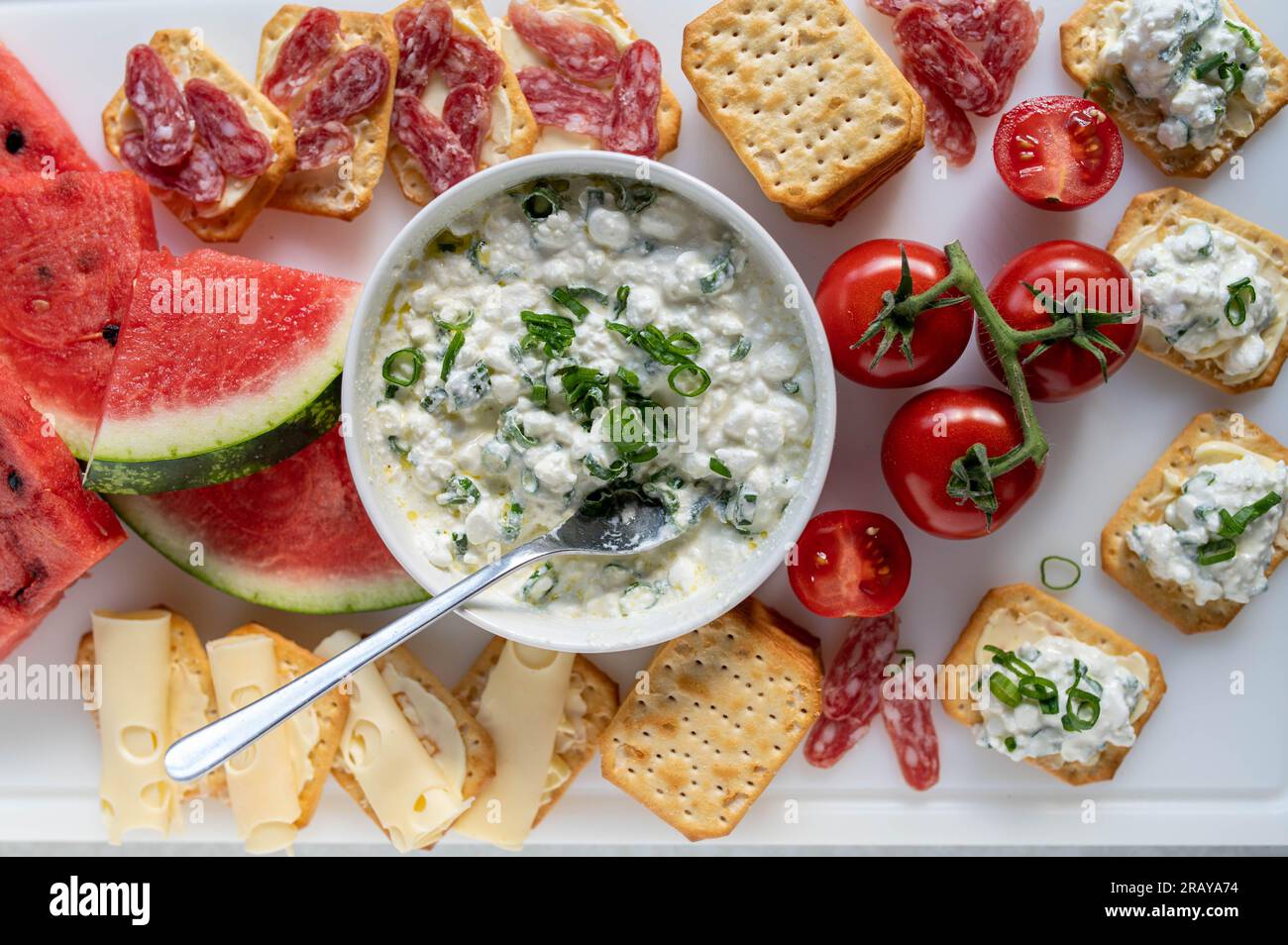 Appetizer with watermelon, cheese and crackers on white platter Stock ...