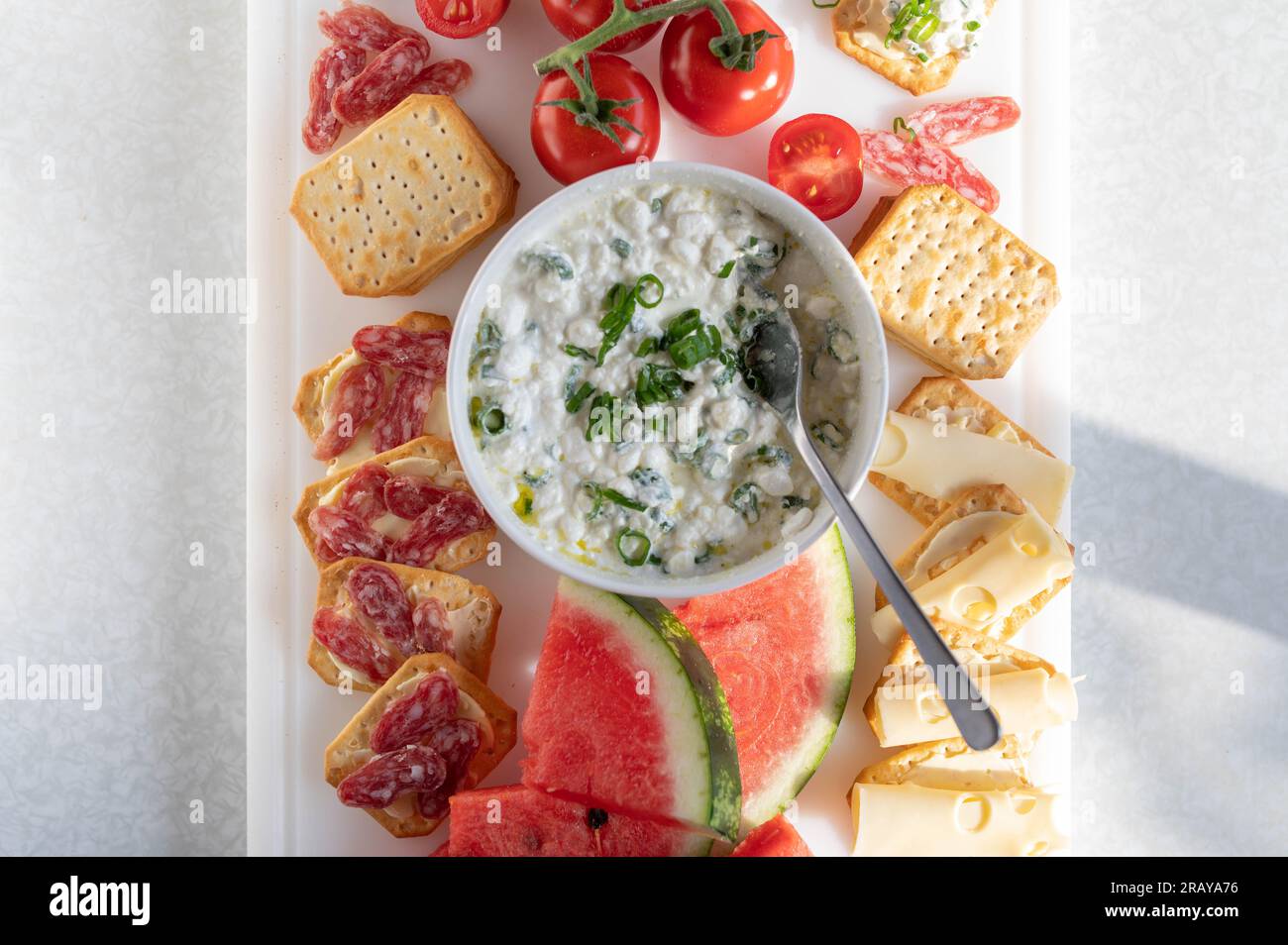 Appetizer with watermelon, cheese and crackers on white platter Stock ...