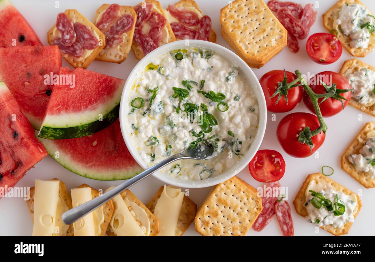 Appetizer with watermelon, cheese and crackers on white platter Stock ...