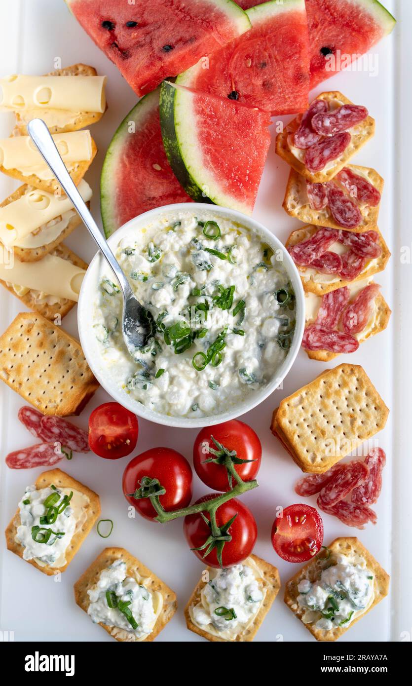 Appetizer with watermelon, cheese and crackers on white platter Stock ...