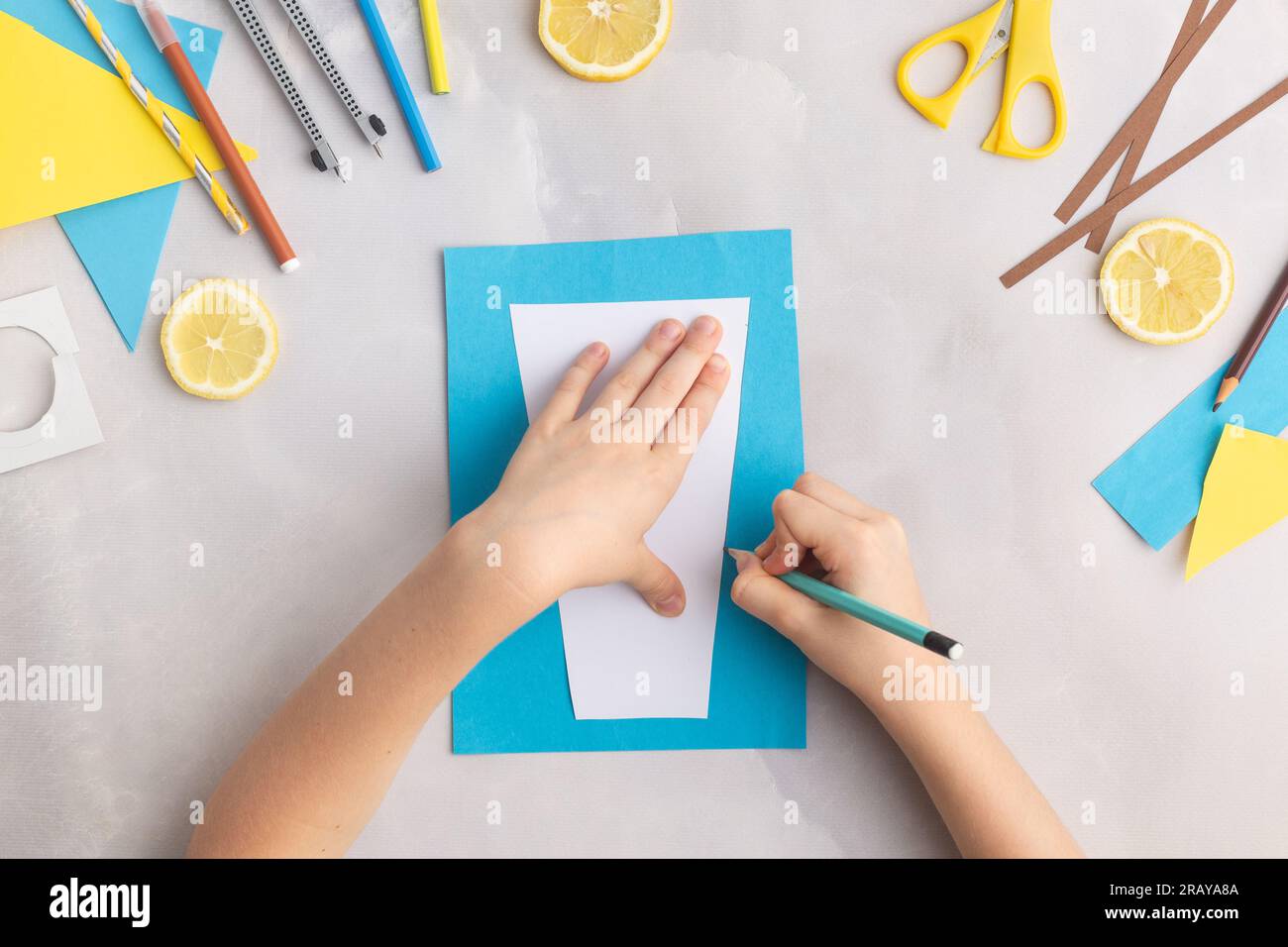 Paper lemonade with lemons. Children at home. Hands making DIY summer ...