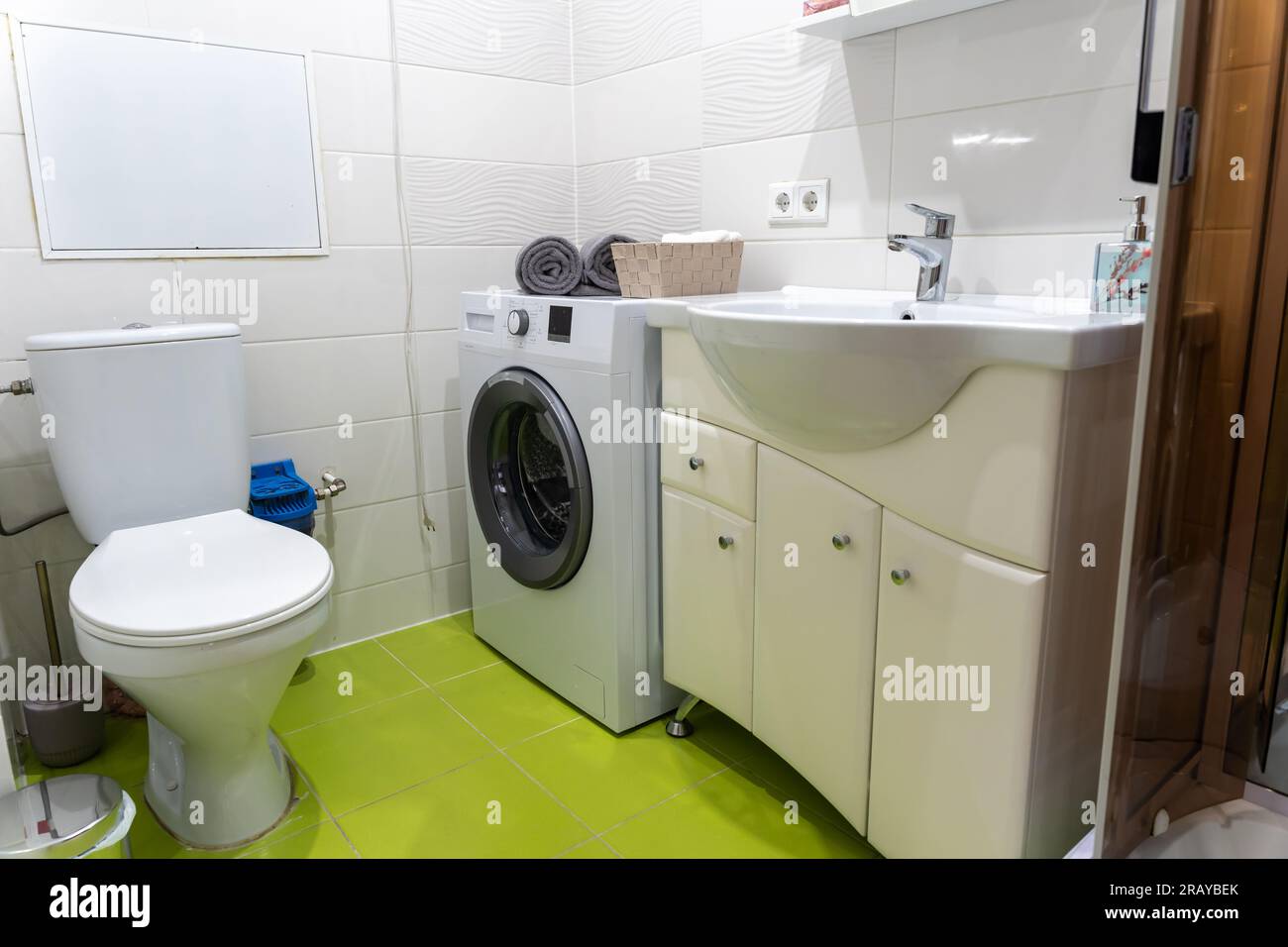 Interior of bathroom with white sink, toilet and washing machine Stock ...