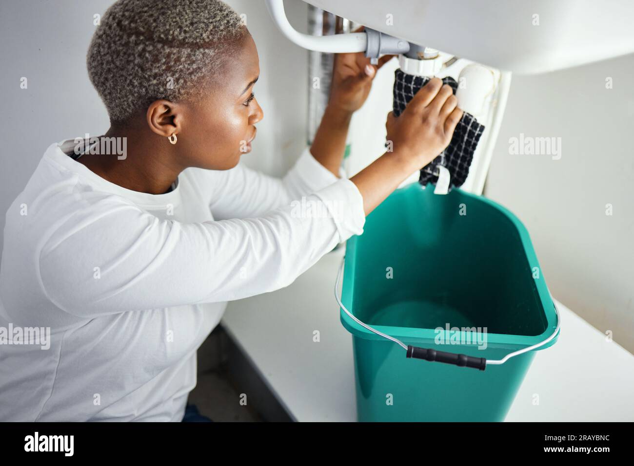 Plumbing, water and a black woman in the bathroom of her home with a ...