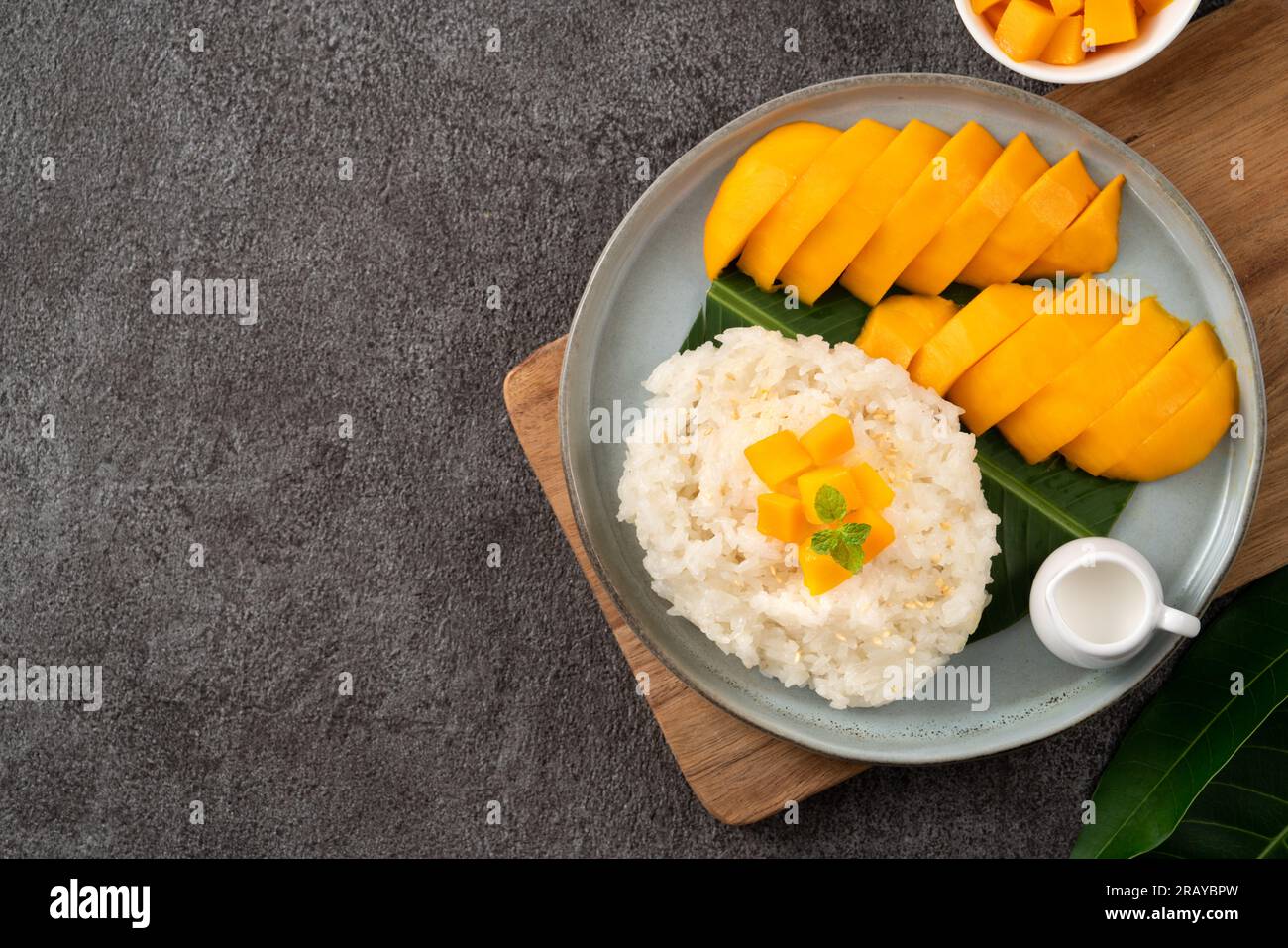 Delicious Thai mango sticky rice with cut fresh mango fruit in a plate ...