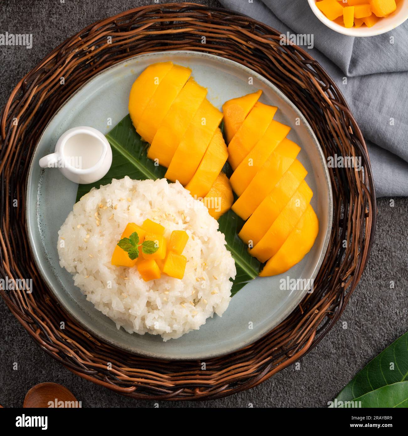 Delicious Thai mango sticky rice with cut fresh mango fruit in a plate ...