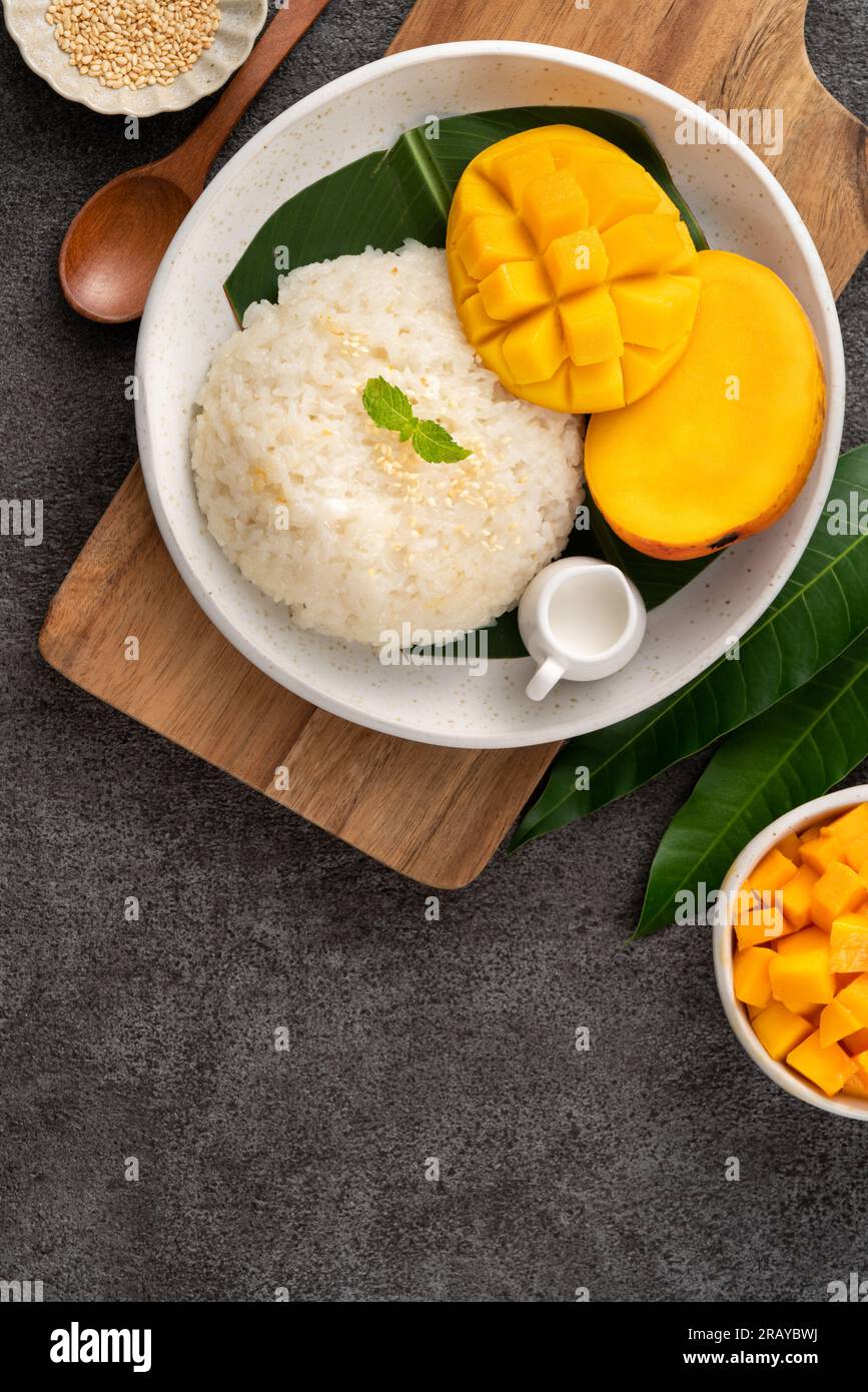 Delicious Thai mango sticky rice with cut fresh mango fruit in a plate ...
