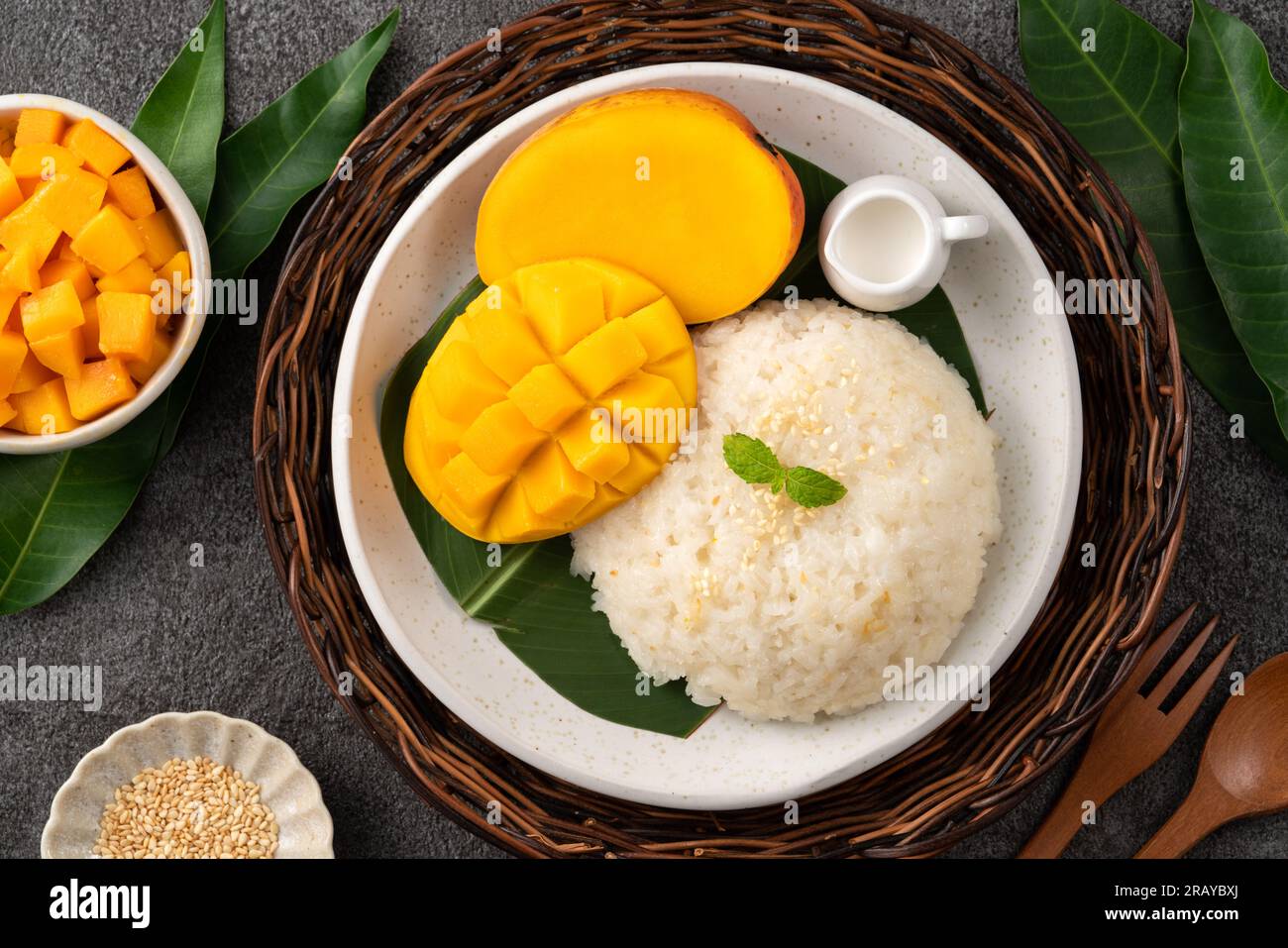 Delicious Thai mango sticky rice with cut fresh mango fruit in a plate ...