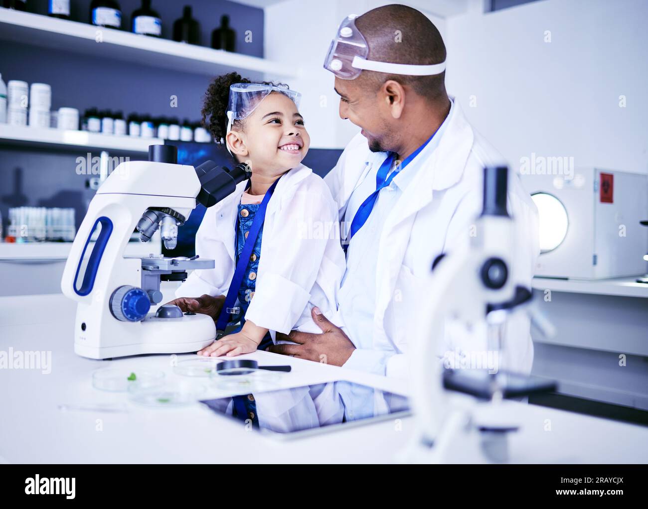 Science, microscope and father with child in laboratory for medical ...