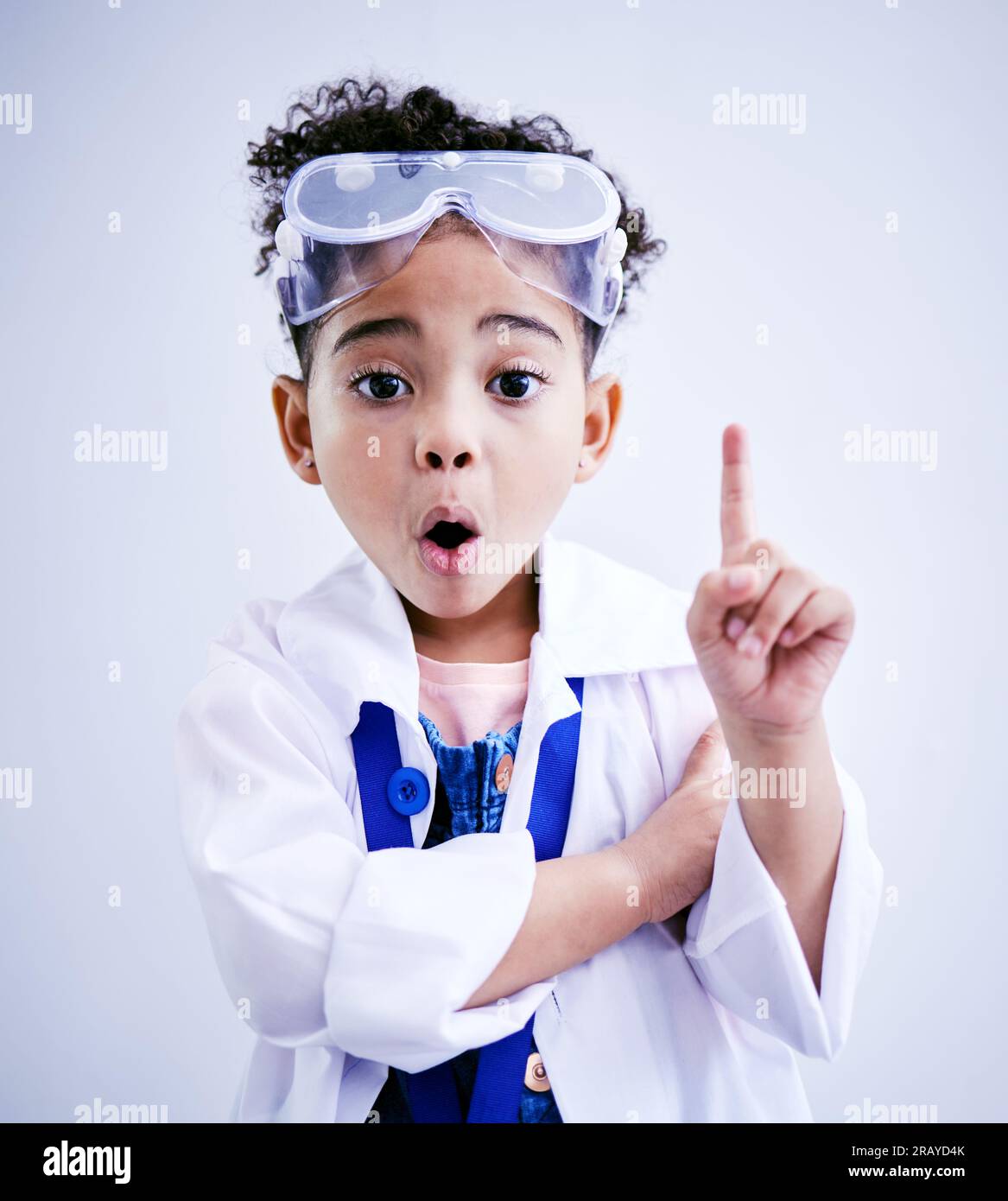 Child, hand and idea or solution for science in studio with mouth open ...