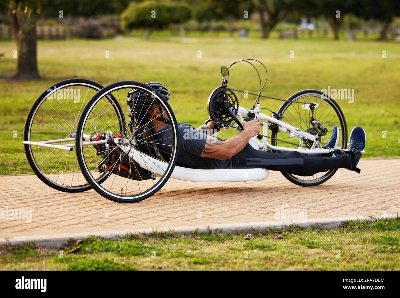 Health, cycling and fitness with man and handcycle on road for training ...