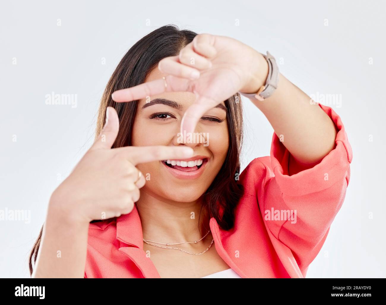 Happy, portrait of a woman with hand frame and against a white ...
