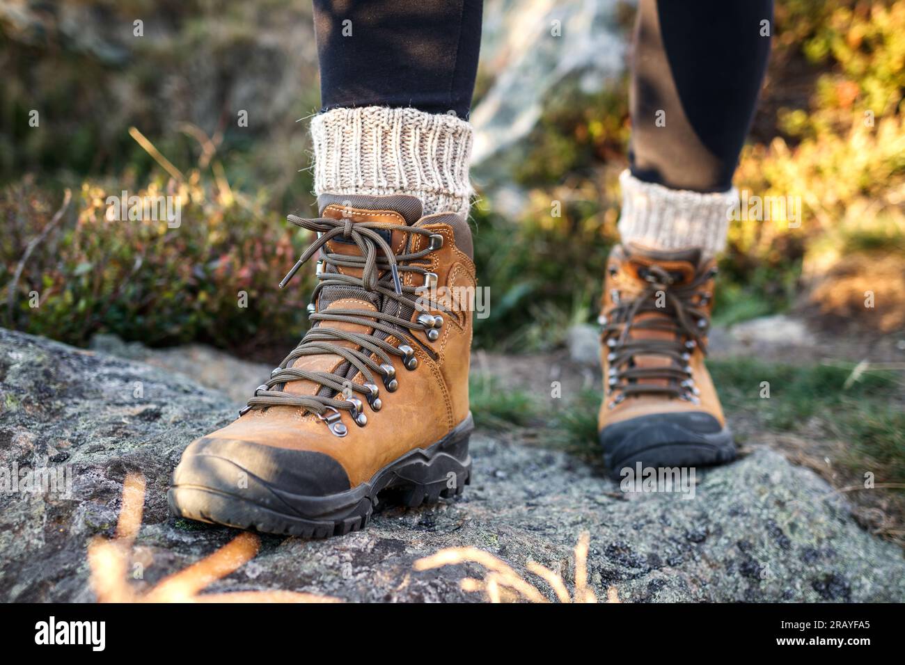 Hiking boot and alpaca sock. Legs with ankle boots on mountain trekking ...