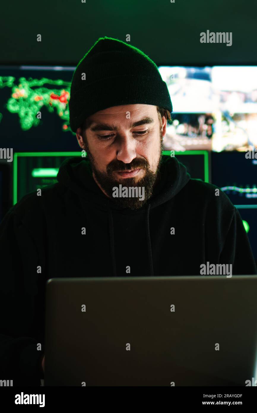 Vertical portrat of one criminal hacker man programming a phishing ...