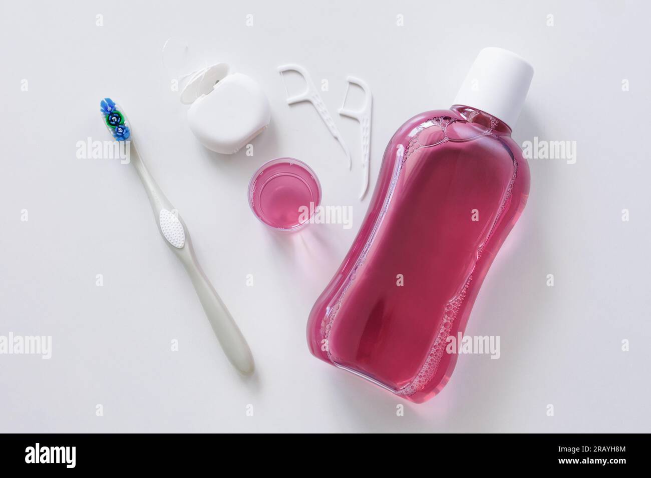 Dental floss, toothbrush, toothpicks and rinse on white background ...