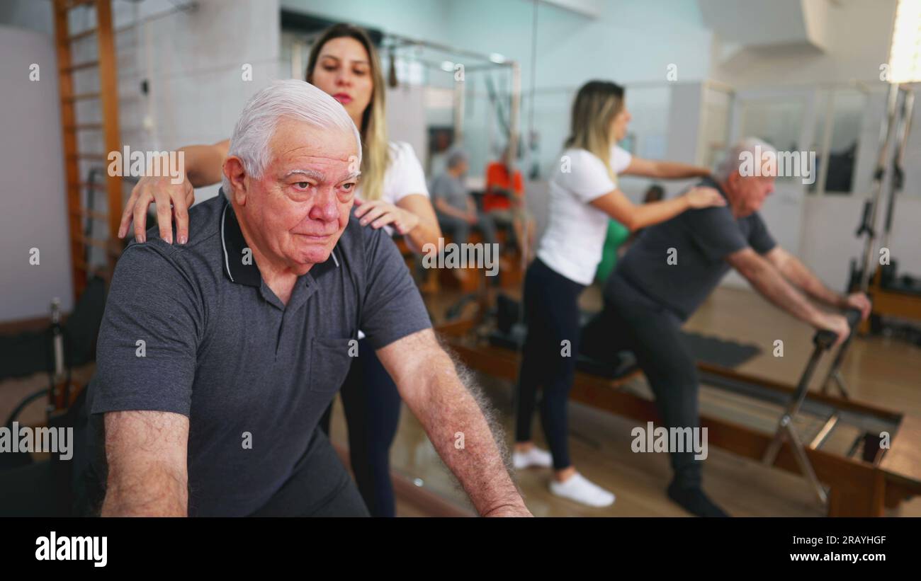 Senior Man Exercising in Guided Workout, Pilates Studio Session with ...