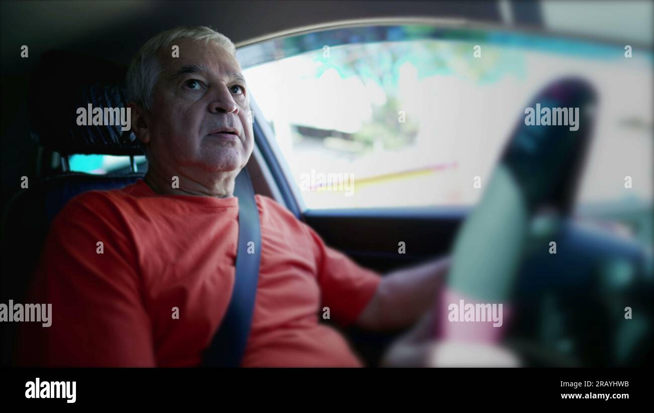Senior man driving car, interior perspective of elderly driver commute ...