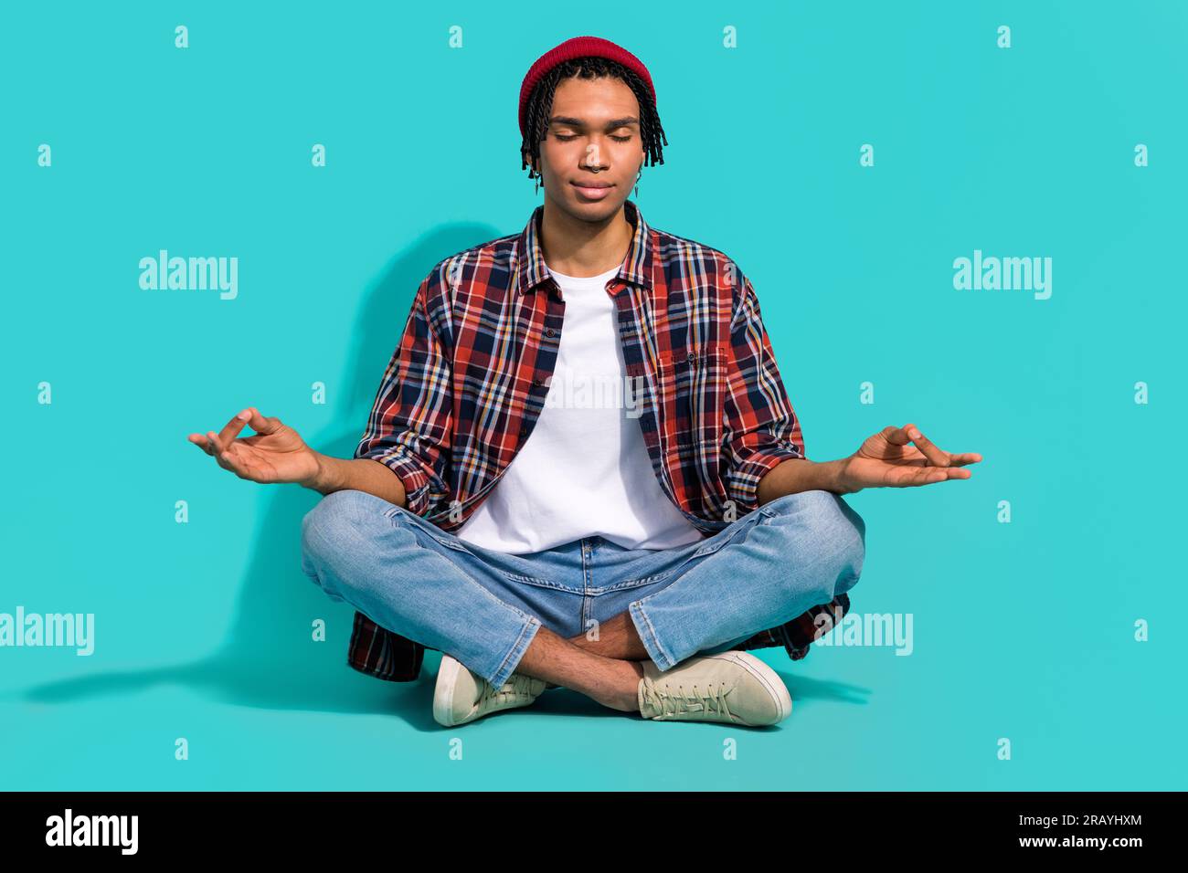 Full length portrait of calm nice person sitting floor crossed legs ...