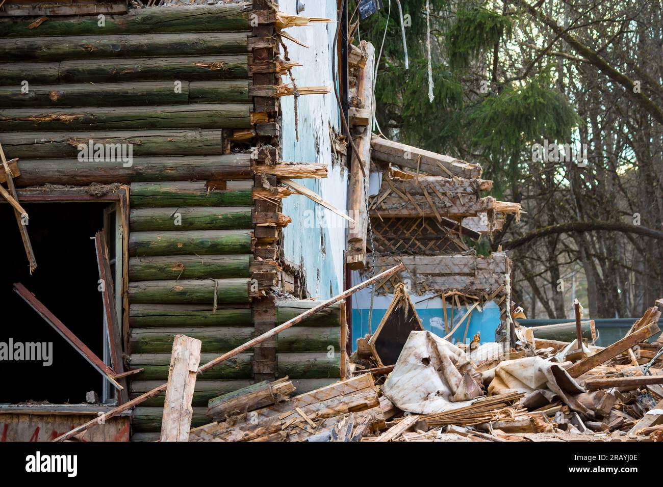 Fragment of the broken wall of an old wooden house. Demolition of a two ...
