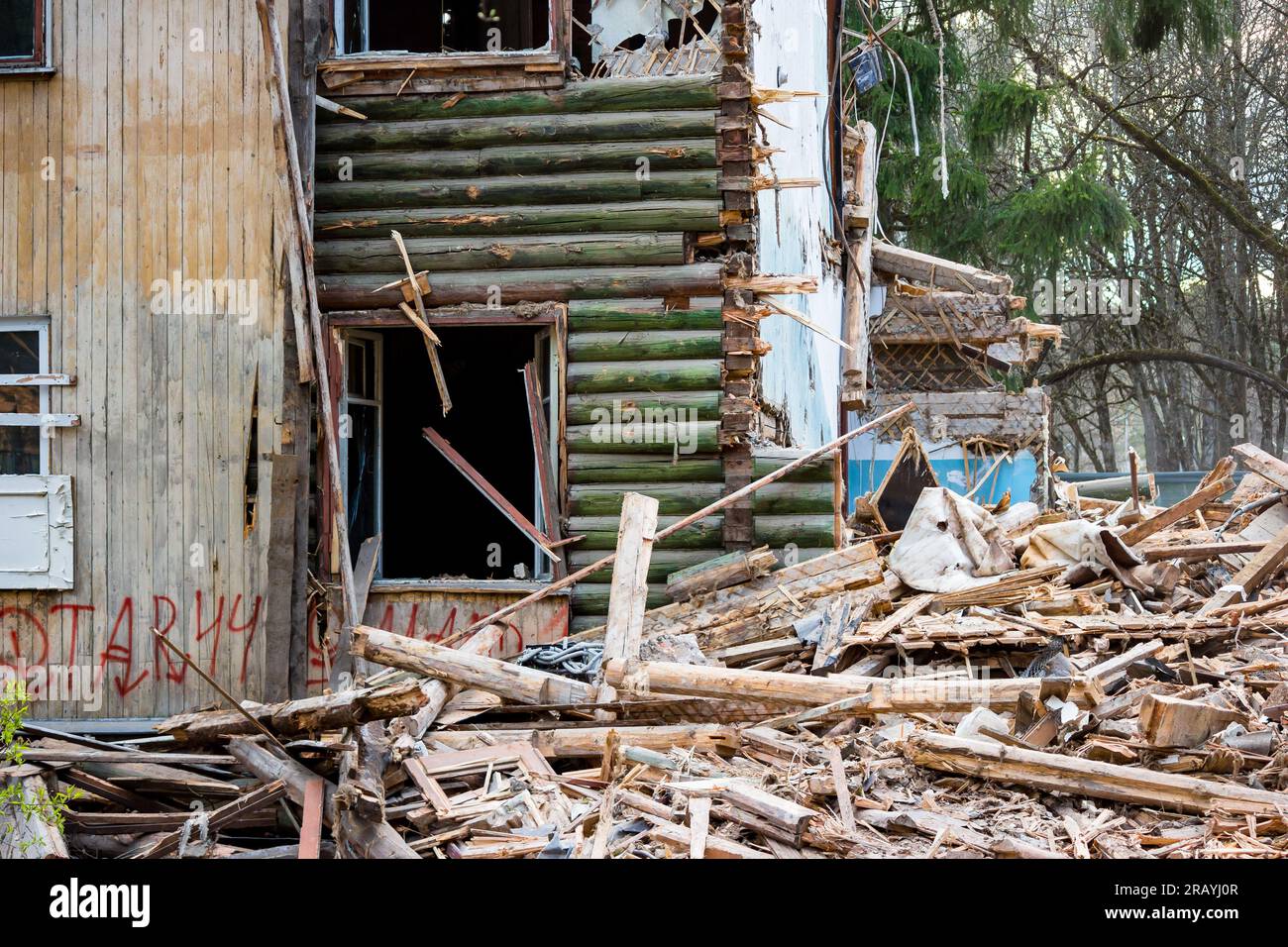 Fragment of the broken wall of an old wooden house. Demolition of a two ...