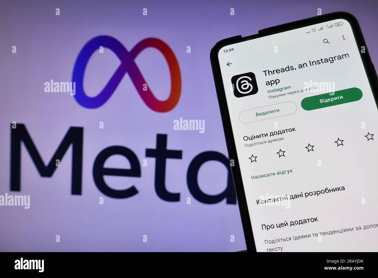 In this photo illustration, Threads logo seen displayed on a smartphone and Meta in the ...