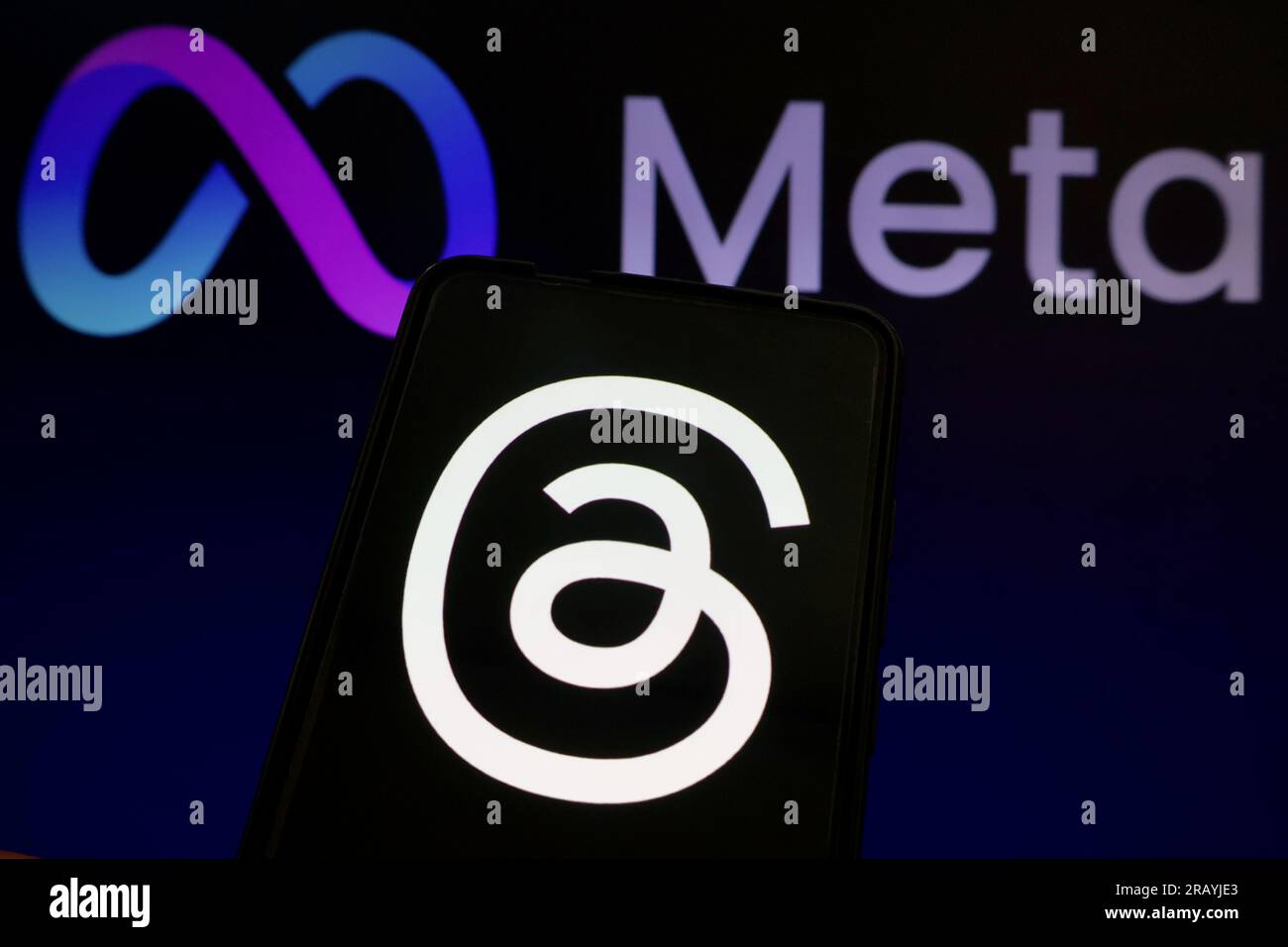 In this photo illustration, Threads logo seen displayed on a smartphone and Meta in the ...