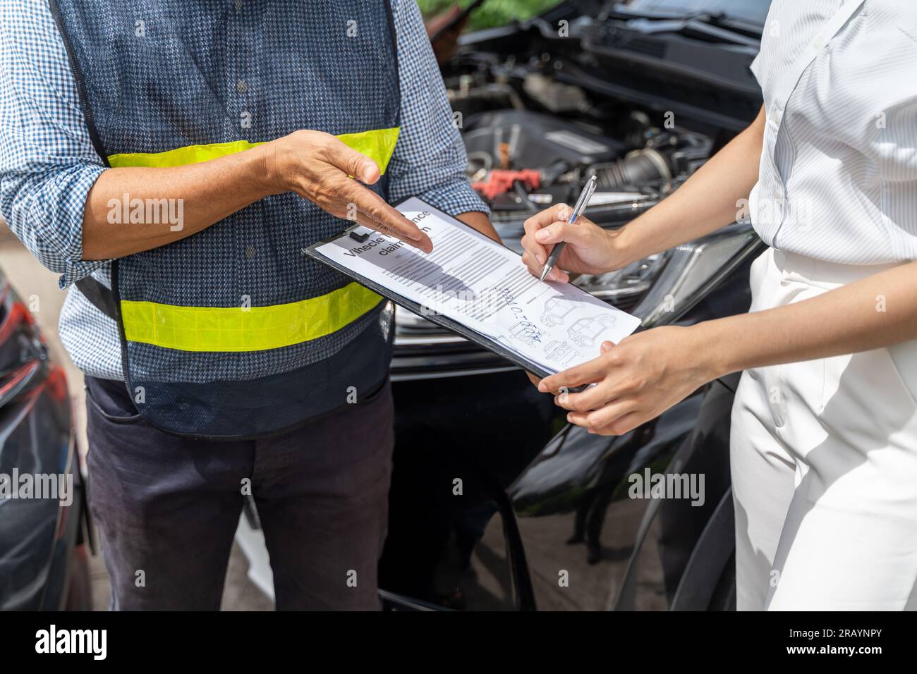 Close up of a car insurance agent showing the woman customer where to ...
