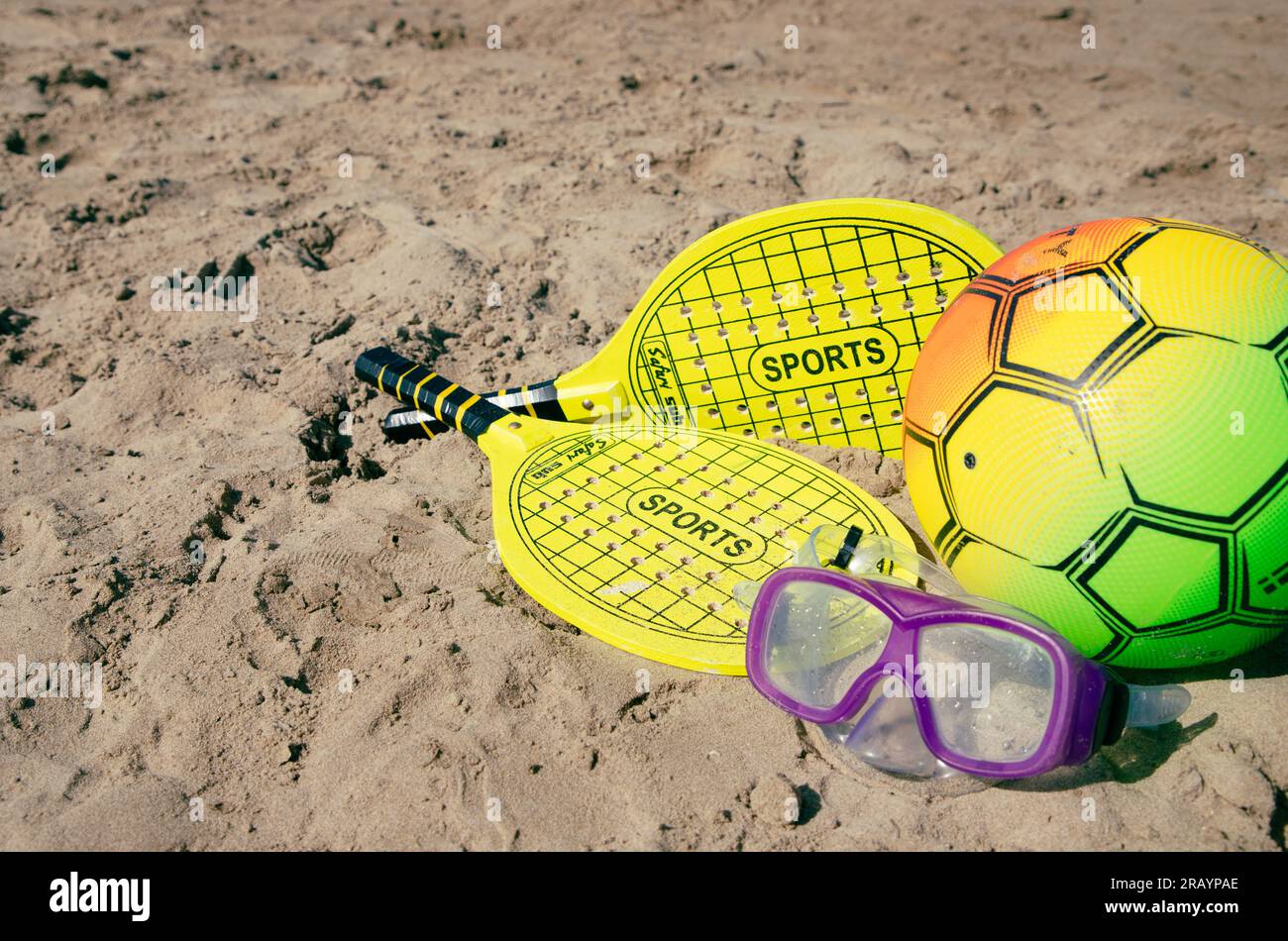 Beach tennis racket and ball, swimming mask ,and beach volleyball ball ...