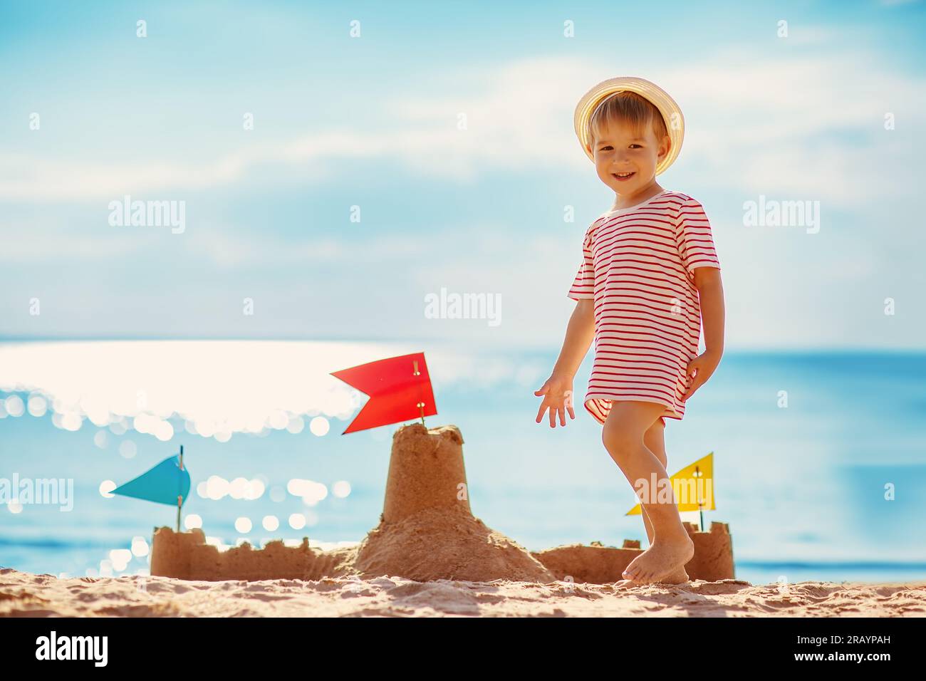 Little boy building sand castle on the sea beach Stock Photo - Alamy