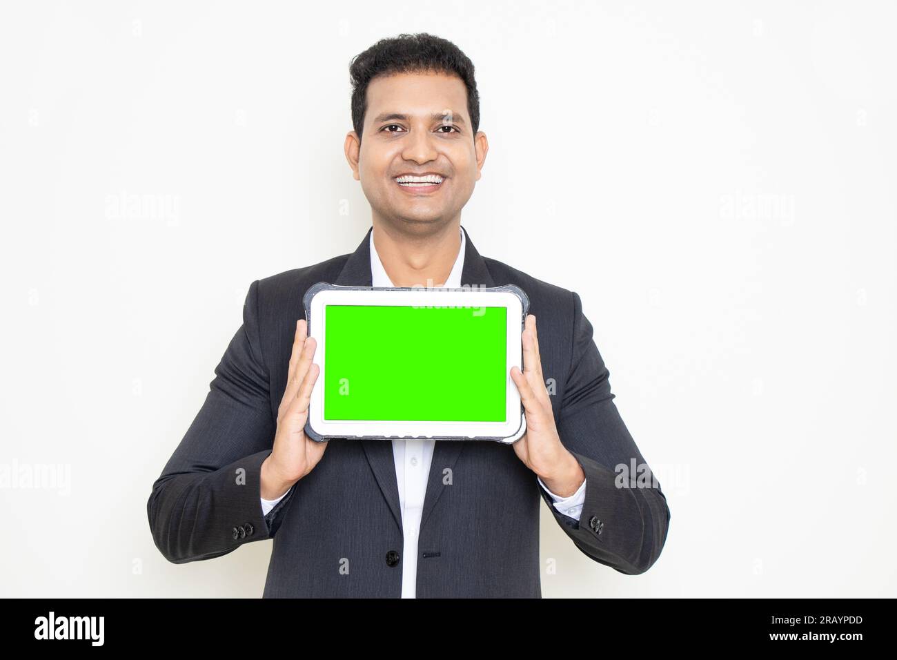 Smiling handsome young indian businessman wearing suit holding blank ...
