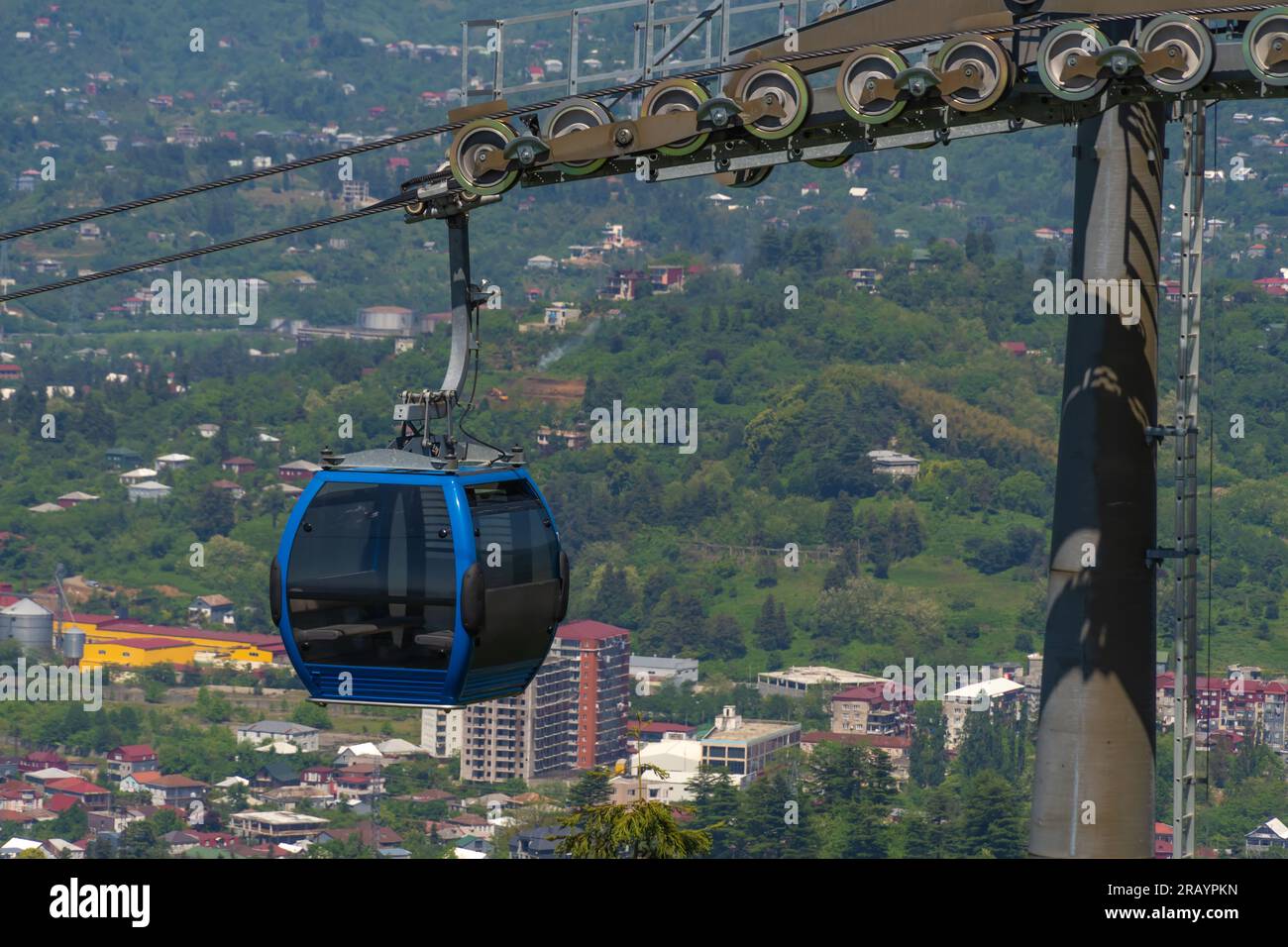 Close-up of an empty cab on a cable car over the city and mountains ...