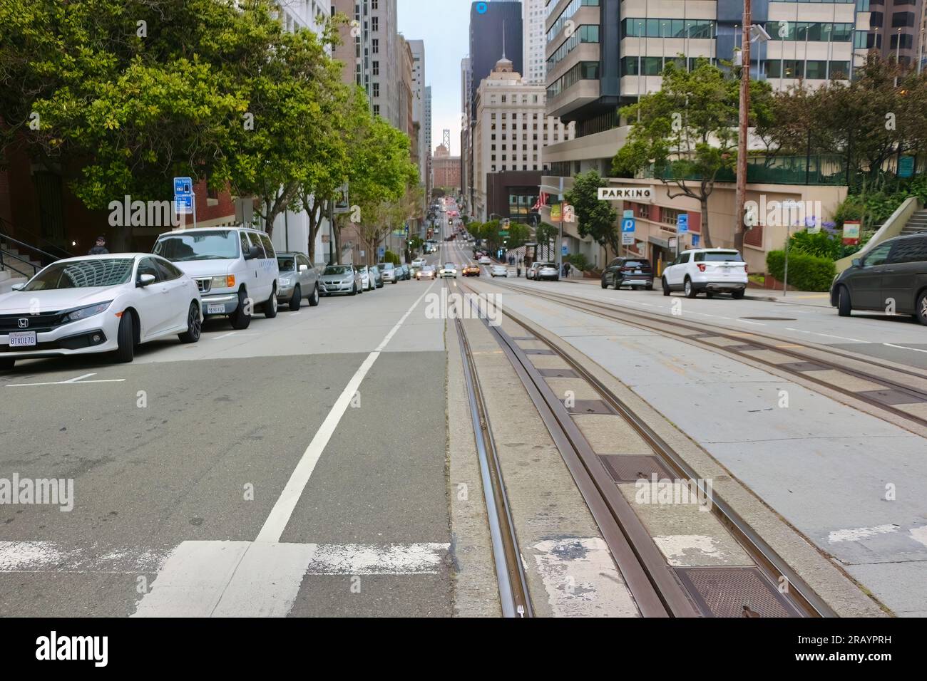 Urban landscape street view looking downhill towards the distant Bay ...