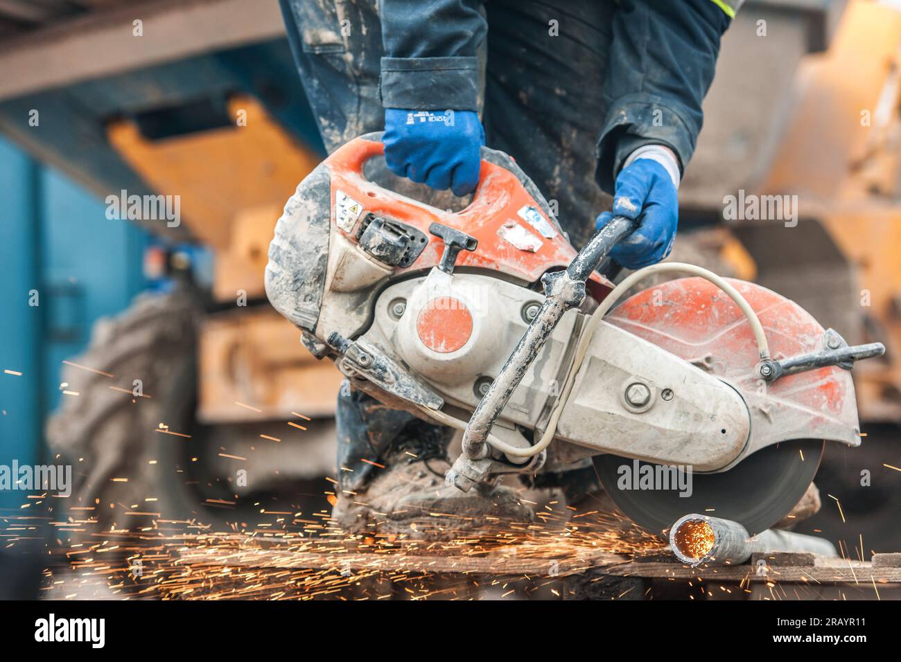 Man using disc cutter on construction site to cut scaffolding bar Stock ...