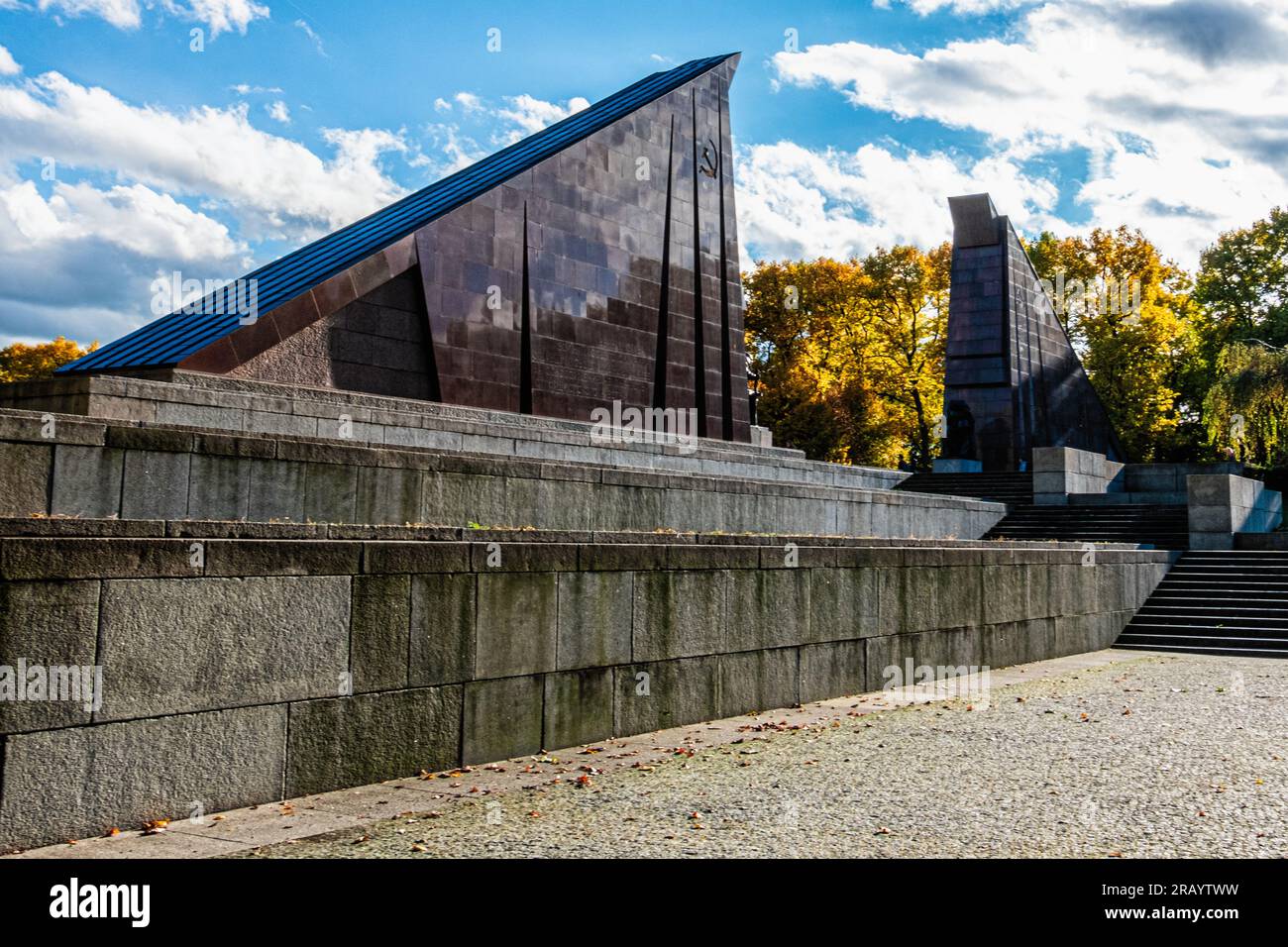 Sarcophagi with sculptural reliefs & stylised red granite 'flags' at ...