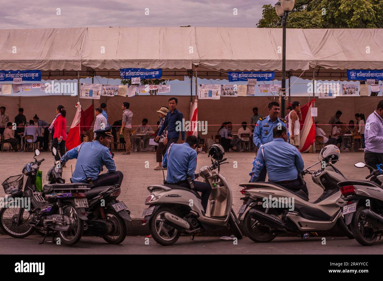 Police keep an eye on the temporary election booths lined up on the riverside during the 2018 ...
