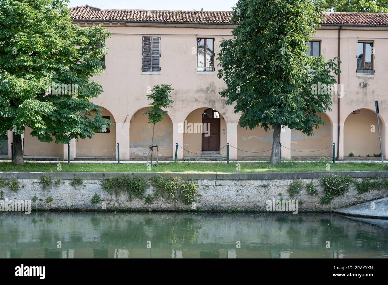 cityscape with old houses on arched covered walkway at river Sile ...