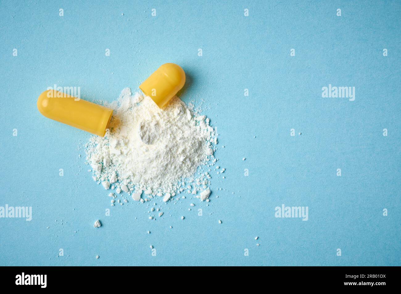 scatter powder from yellow gelatin capsule pills, open oral medical ...