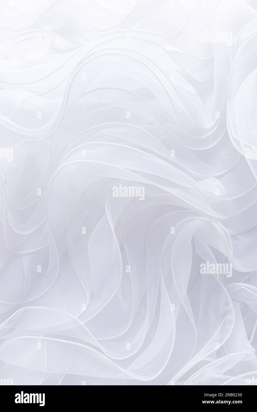 Delicate texture of silk fabric with flowing waves of white silk ...