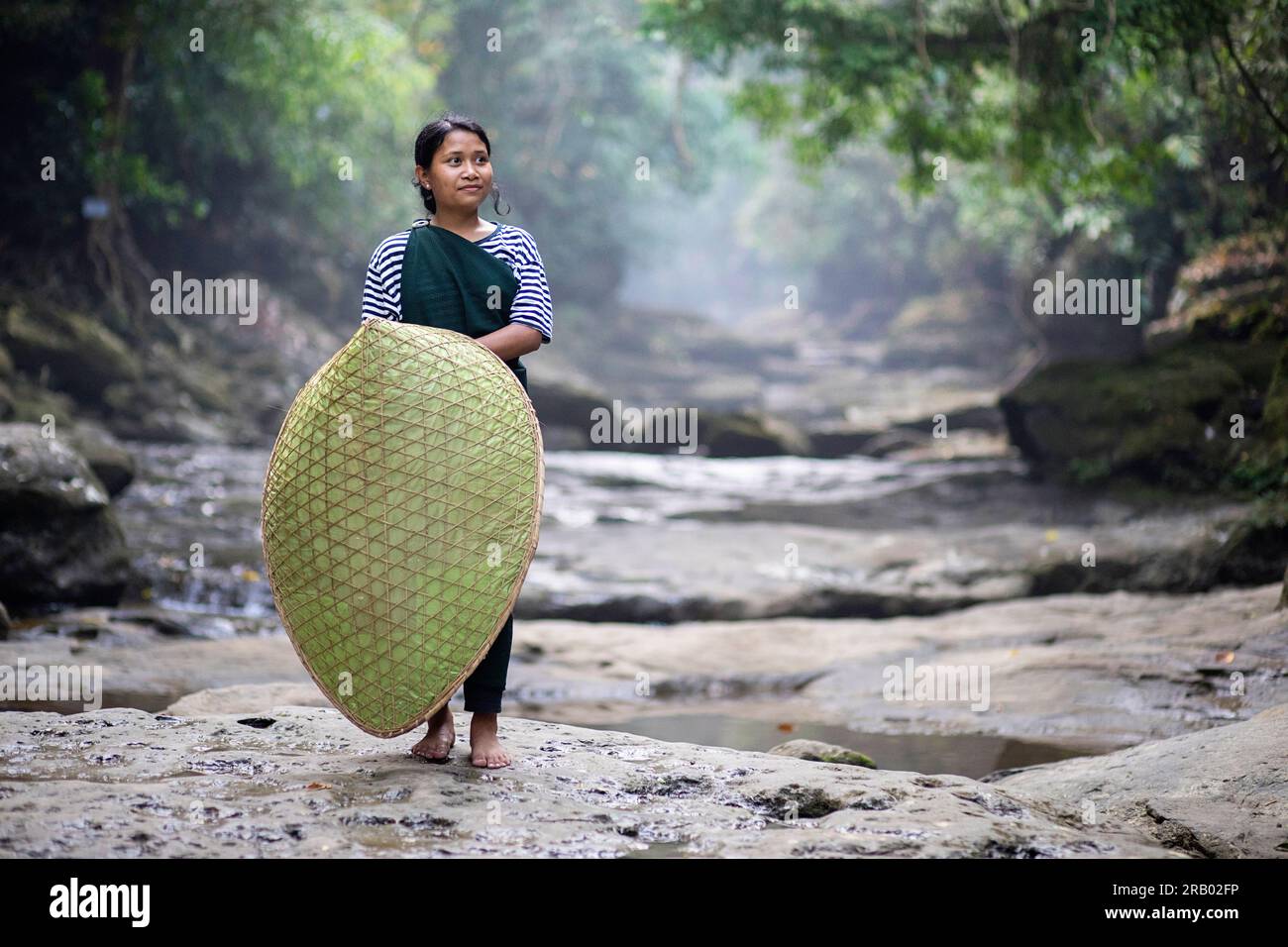 Girl from khasi tribe in traditional clothes wearing traditional rain ...