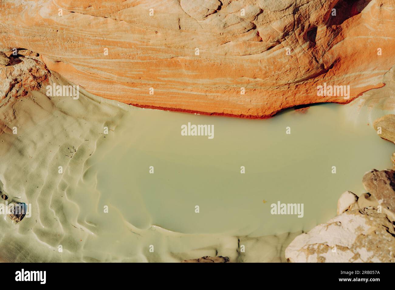 Water hole in rocks and mud in desert after rain season Stock Photo - Alamy