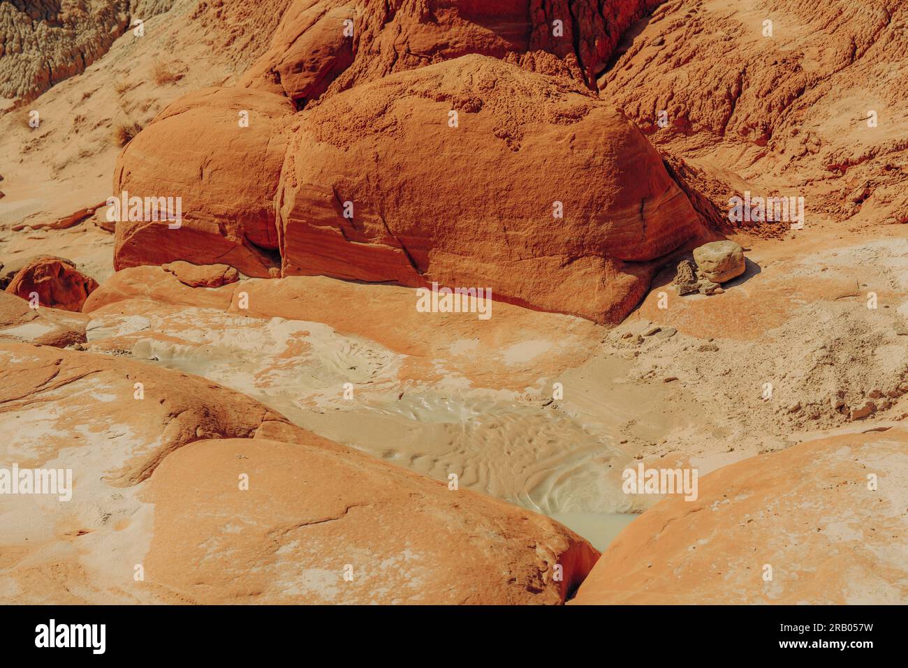 Water hole in rocks and mud in desert after rain season Stock Photo - Alamy