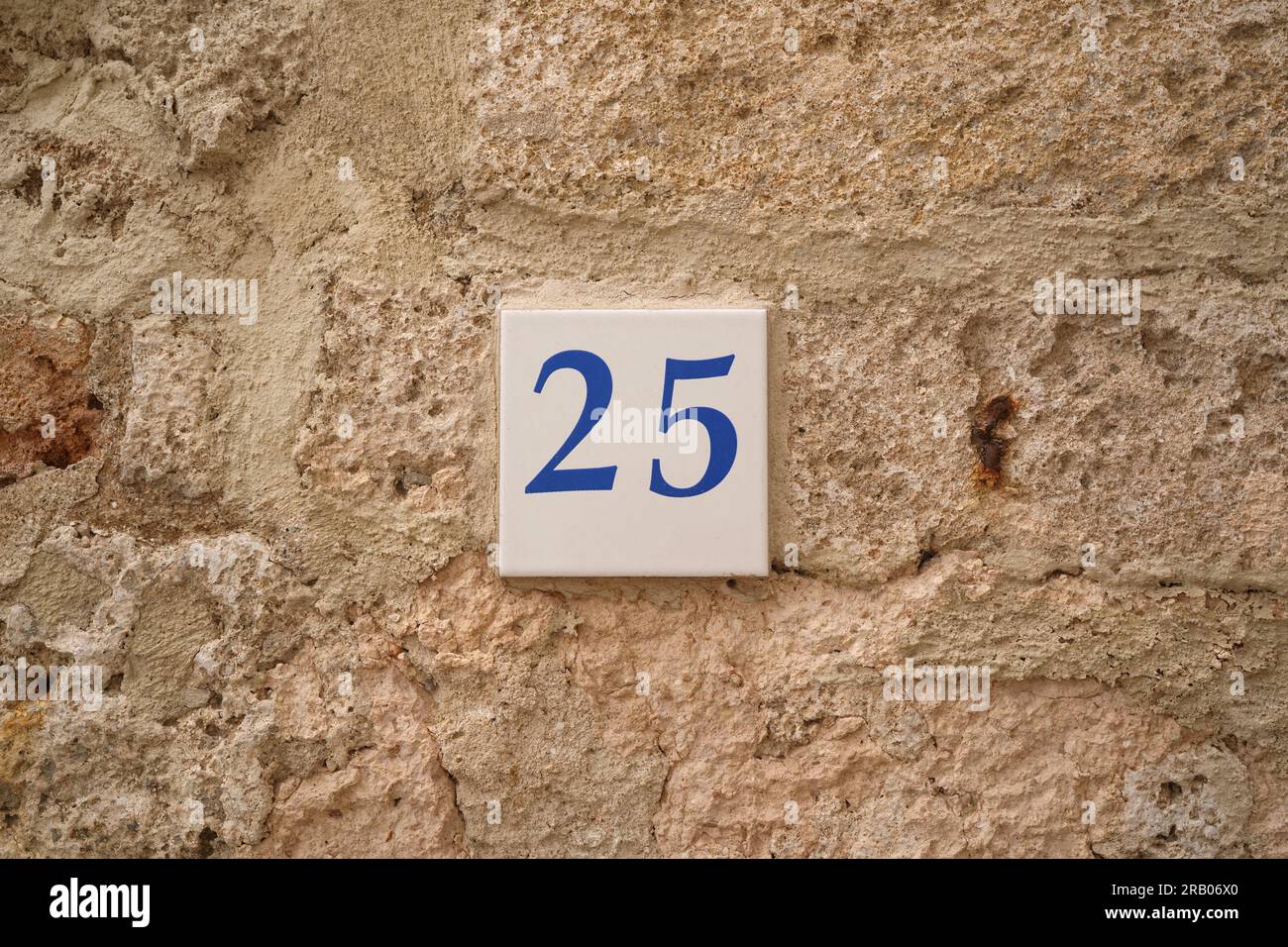 25 ceramic number plate on old stone wall Stock Photo - Alamy