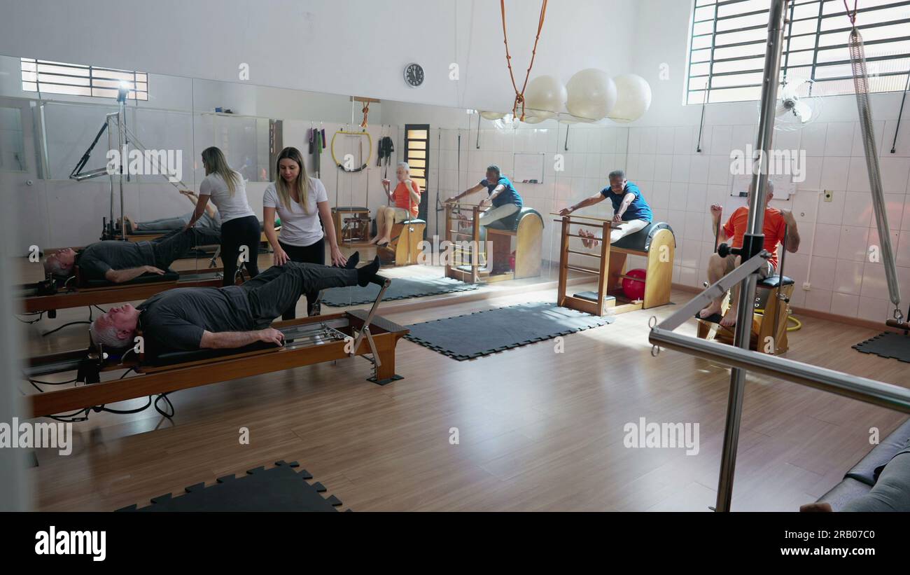 Group of elderly people exercising in Pilates Studio. old age workout ...