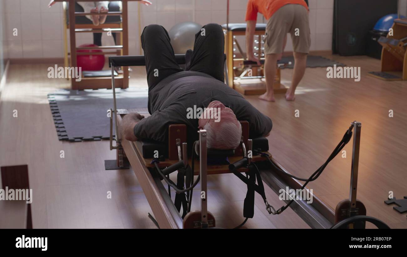 Elderly people exercising in Pilates Group class Stock Photo - Alamy