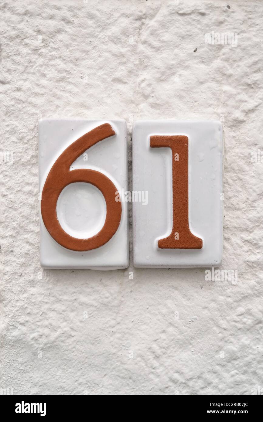 61 ceramic number plate on white wall Stock Photo - Alamy